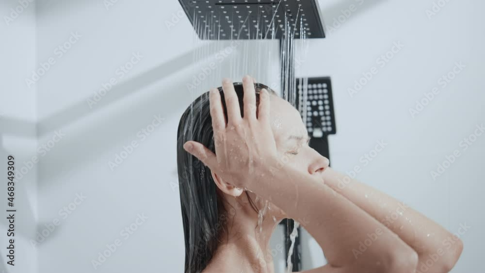 side view caucasian model take shower female puts her face under the ...