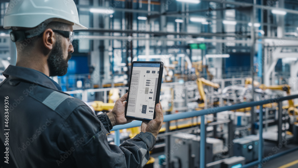 Car Factory Engineer in Work Uniform Using Tablet Computer with ...