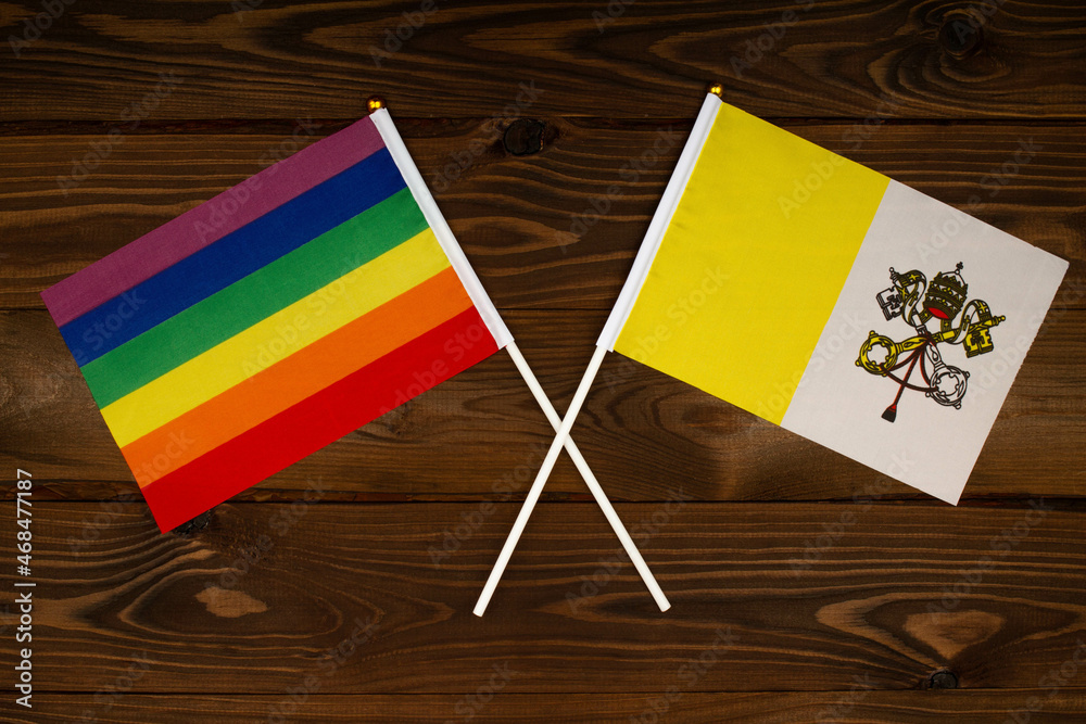 Rainbow flag LGBT and flag of Vatican on beautiful brown background ...