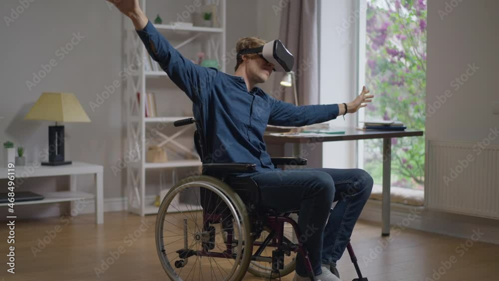 Smiling happy disabled man in VR headset enjoying augmented reality ...