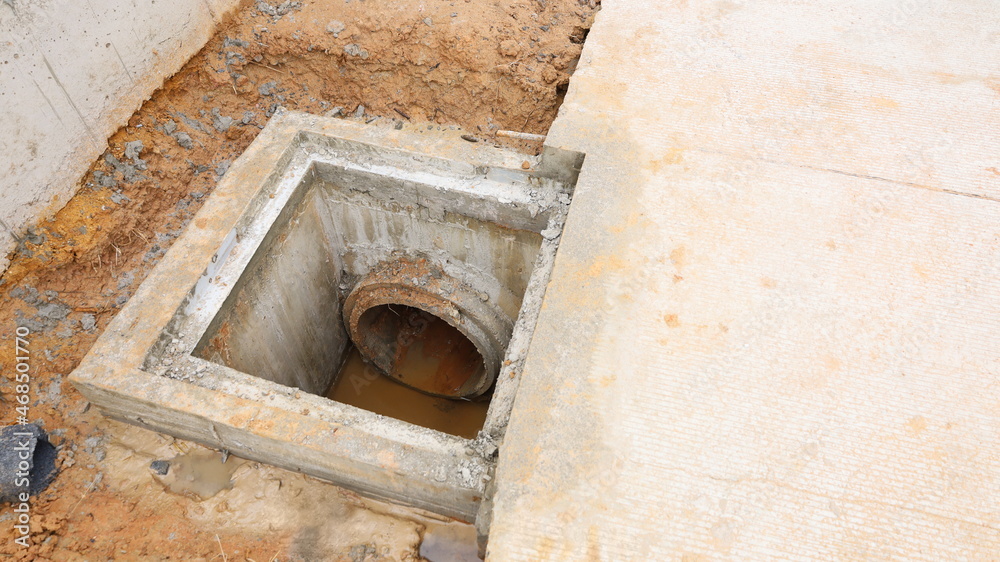 Sewer holes on the side of the road. manholes and concrete culverts ...