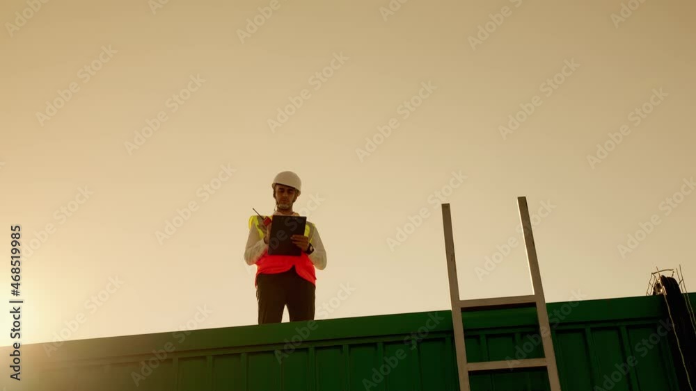 Engineers are standing to check the specs of work on factory roofs ...