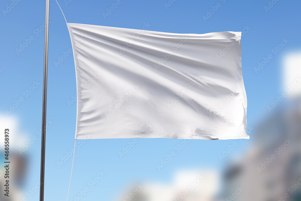 White flag mockup on the blue sky background. Stock Photo | Adobe Stock