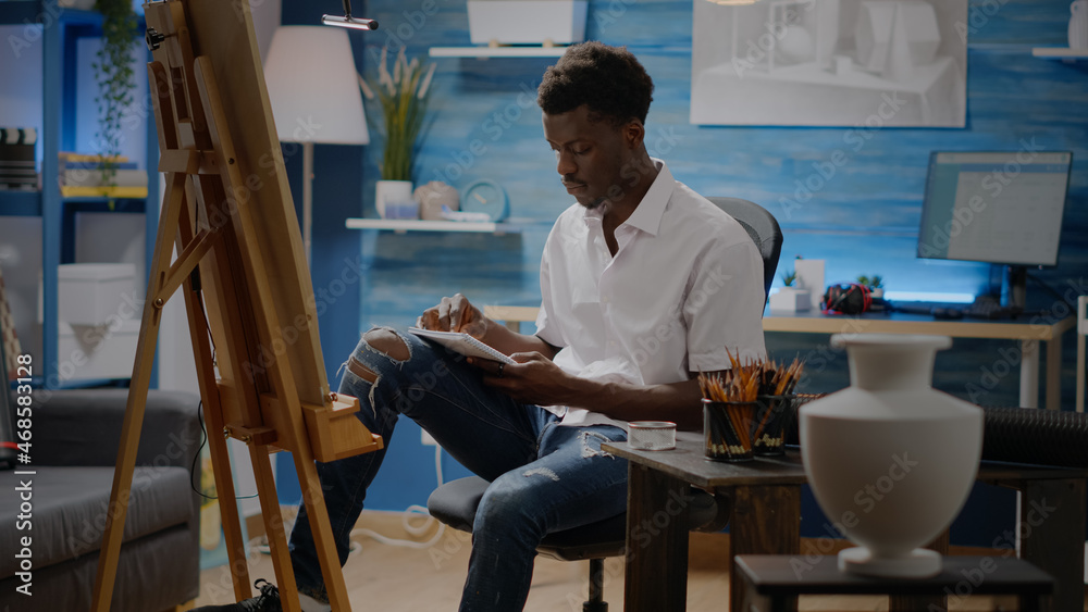 Person of african american ethnicity working on vase sketch for ...