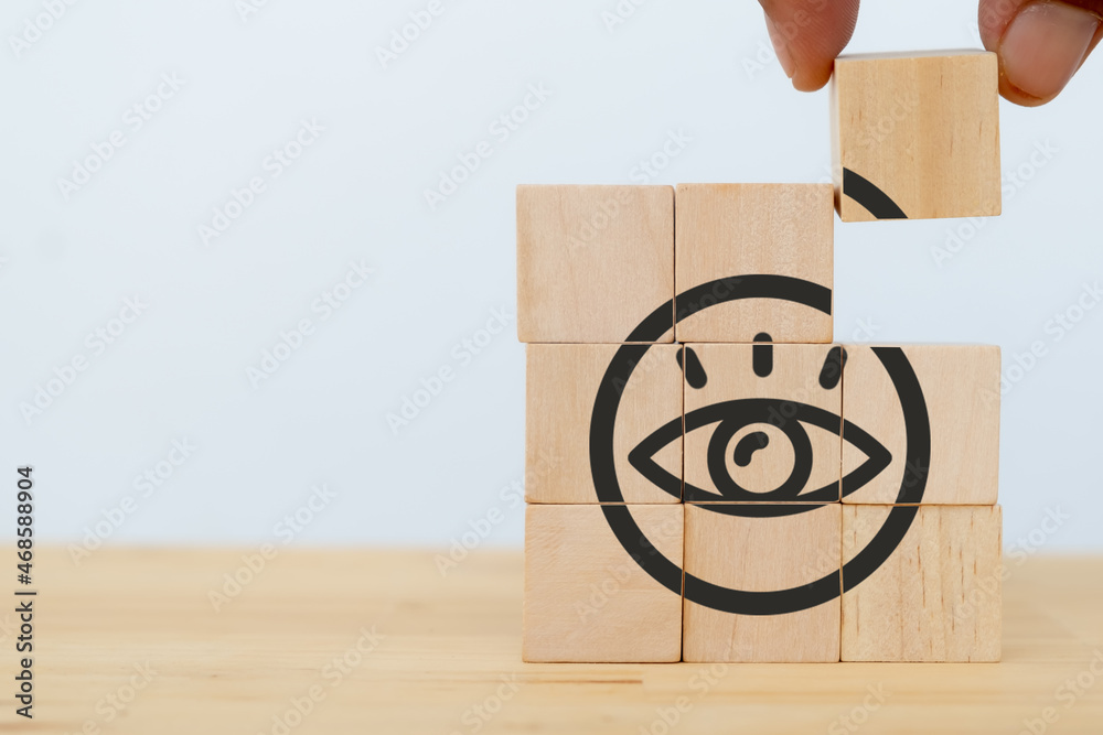 Company vision concept. Businessman put the wooden cubes with "VISION ...
