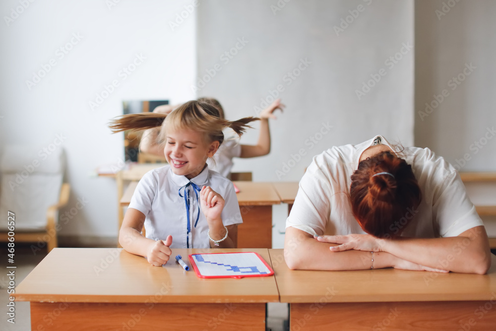 Crazy woman teacher at a desk with a girl student. Unusual photos of ...