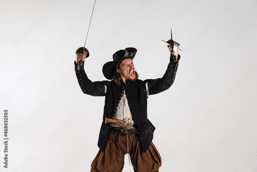 Portrait of brutal, frightening man, pirate in vintage costume raising ...