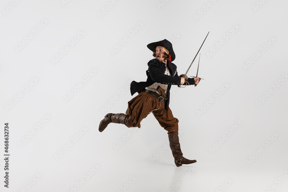 Full-length portrait of man, medeival pirate in vintage costume with ...