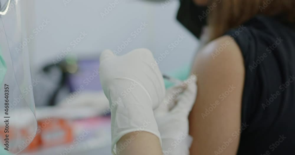 Close Up hand doctor wearing gloves use syringe to prevent COVID 19 on ...