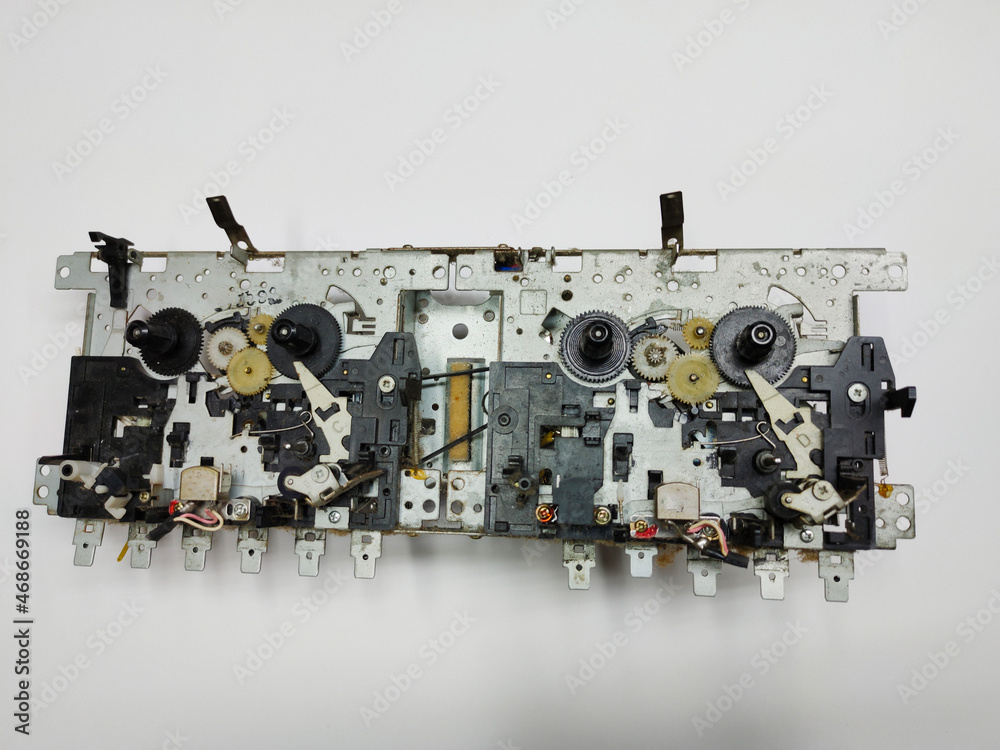 the panel of a broken two-cassette tape recorder with a tape drive ...