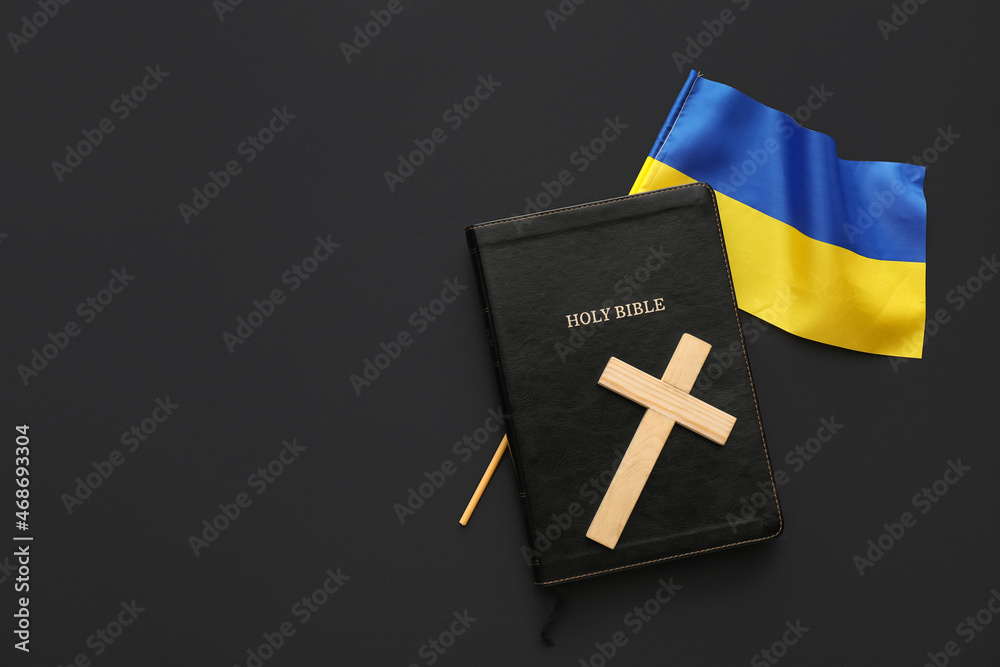 Holy Bible with cross and flag of Ukraine on black background Stock ...