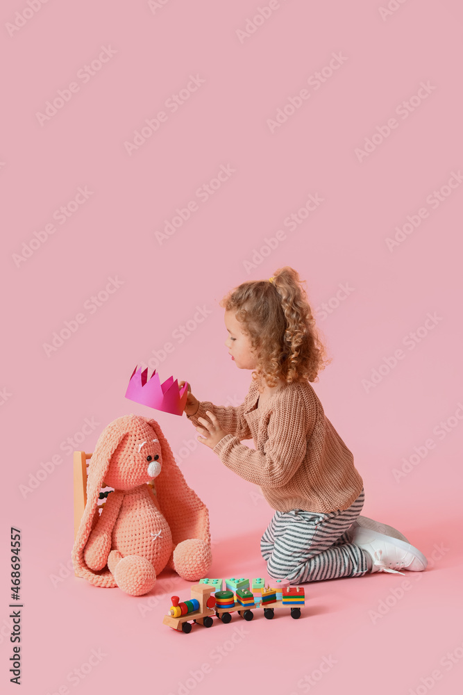 Cute baby girl with toys on color background Stock Photo | Adobe Stock