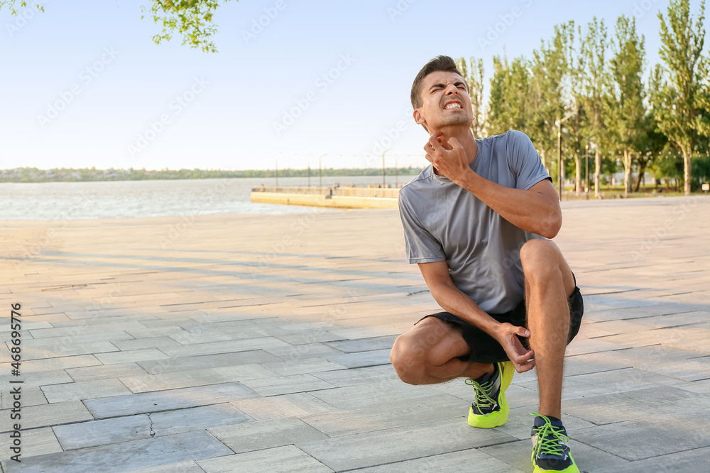 Young man scratching himself outdoors Stock Photo | Adobe Stock