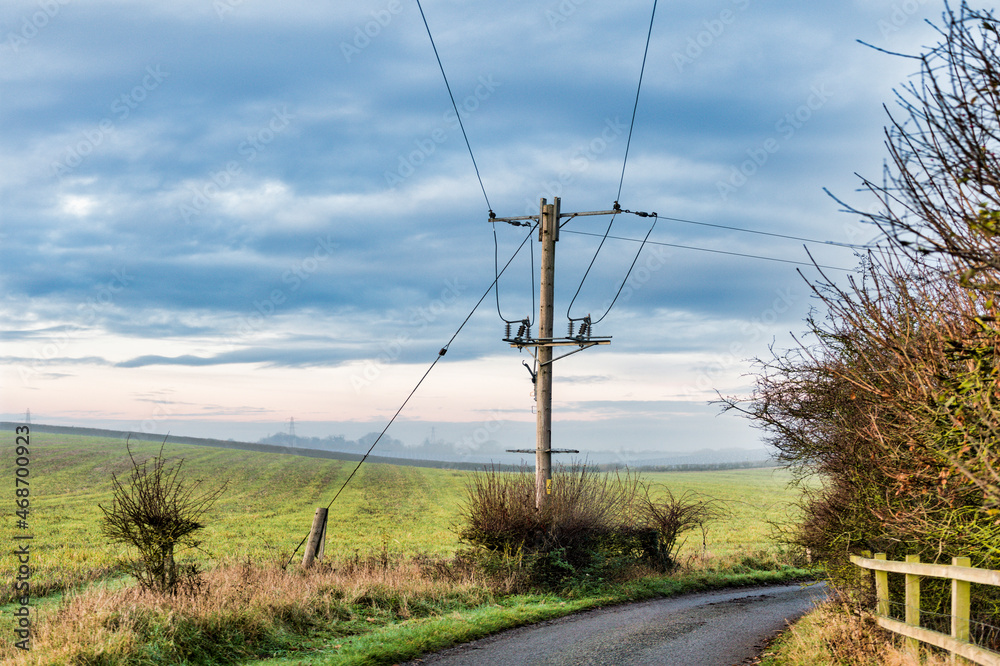 Telegraph pole and winter sunlight, by the side of a country lane at ...