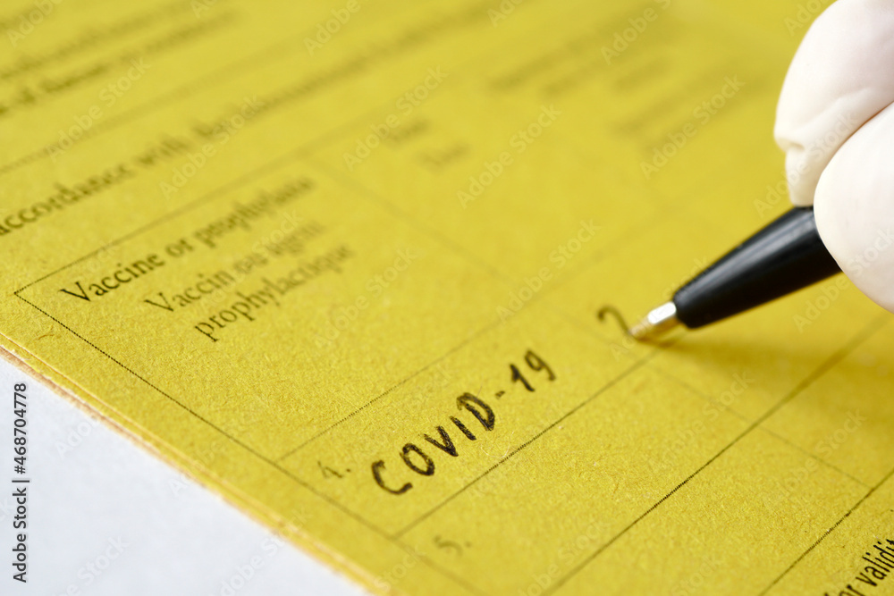 the WHO vaccination card. Yellow card with proof of necessary ...