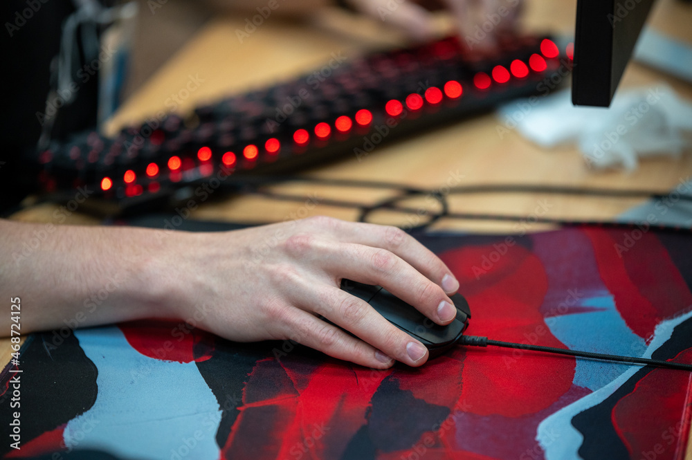 Focus on Hands, Keyboards and Mouse. Back view of young gamer playing ...