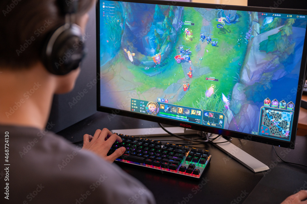 Focus on Hands, Keyboards and Mouse. Back view of young gamer playing ...