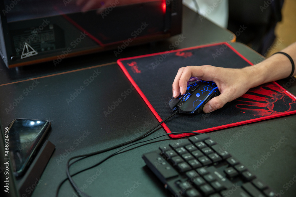 Focus on Hands, Keyboards and Mouse. Back view of young gamer playing ...