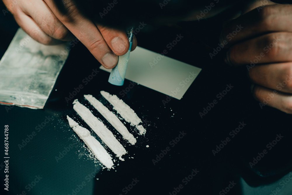 Drug addict. Drug abuse, man taking drugs, snorting lines of cocaine ...