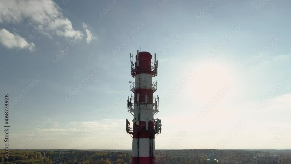The cellular antennas are installed on a factory pipe. Flying around a ...