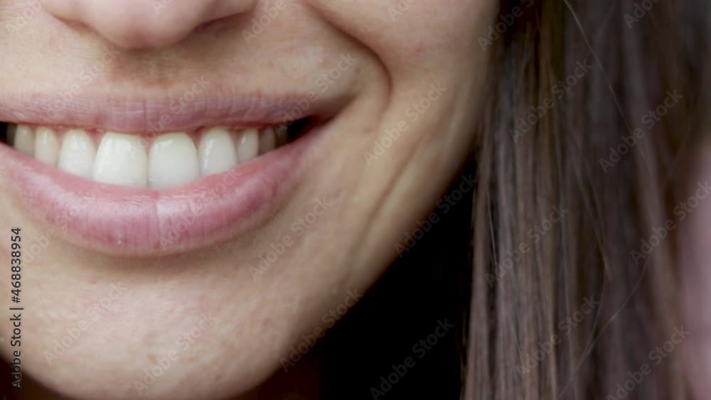 close up of woman smiling. big front teeth. natural look of the skin ...