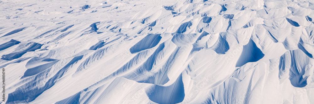 Snow texture. Wind sculpted patterns on snow surface. Wind in the ...
