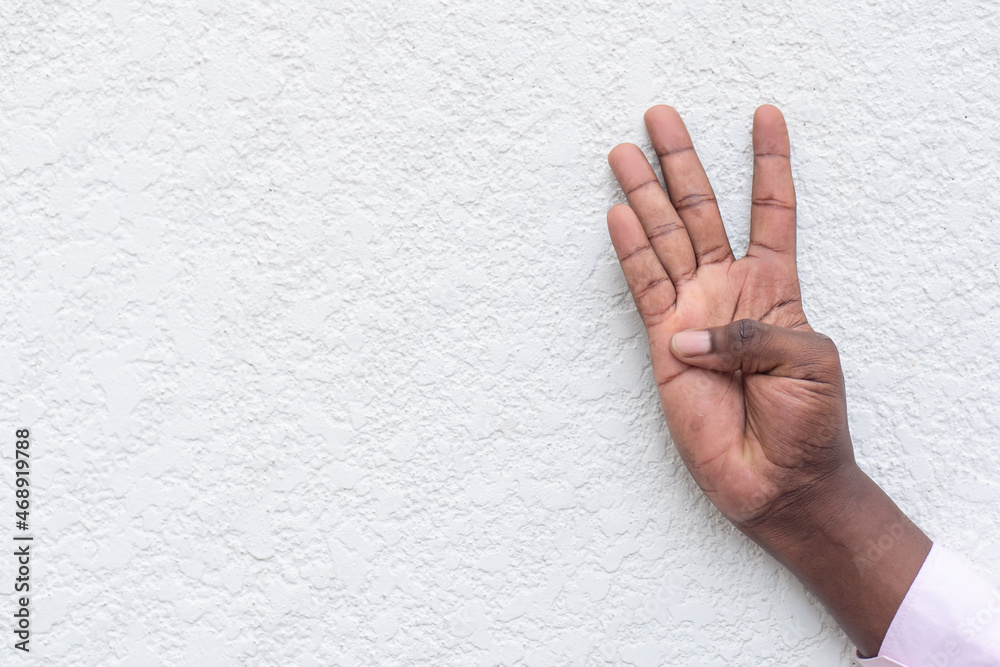 Black African man hand pointing four fingers up Stock Photo | Adobe Stock
