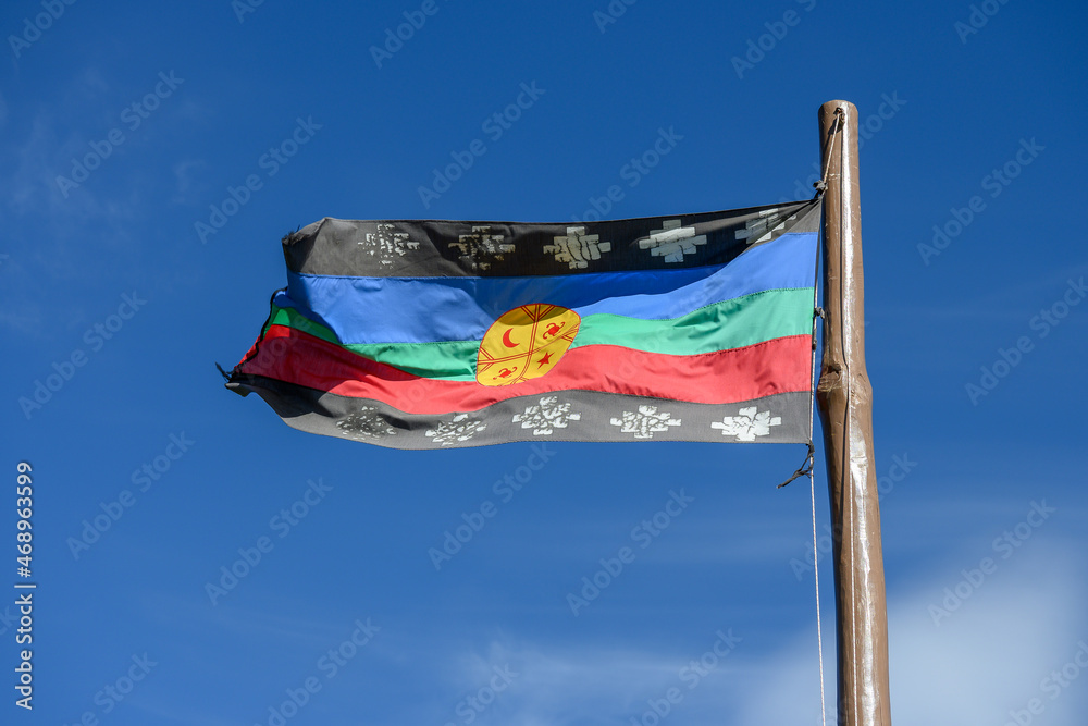 Flag of the original Mapuche people in blue sky. Stock Photo | Adobe Stock