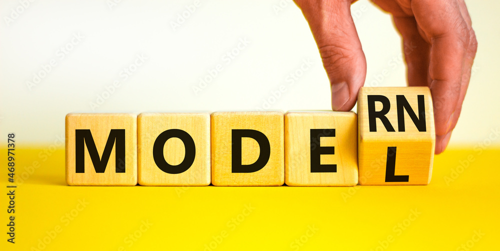 Modern model symbol. Businessman turns a wooden cube and changes the ...