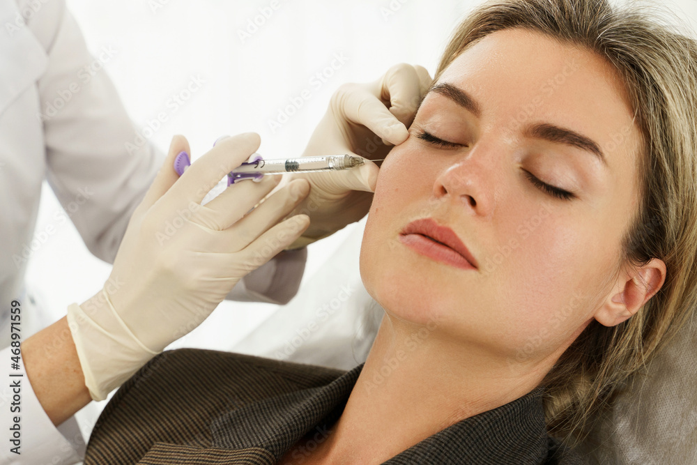 Woman During Facial Filler Injections In Aesthetic Medical Clinic