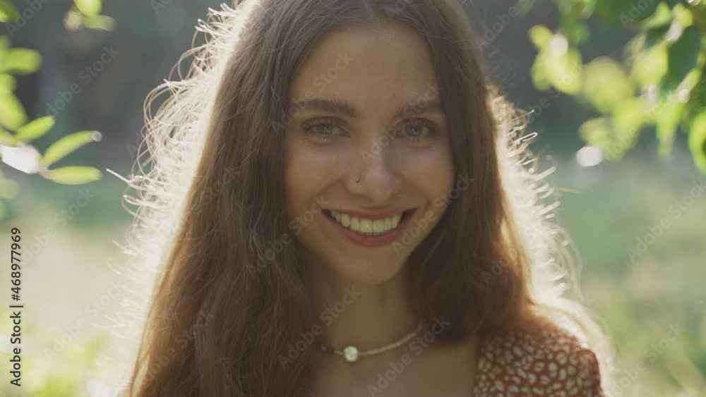 Candid portrait of a beautiful young girl in natural sunlight. A girl ...