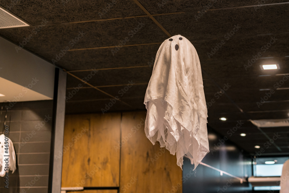 Ghost made from white sheet with black eyes and mouth floating in the ...