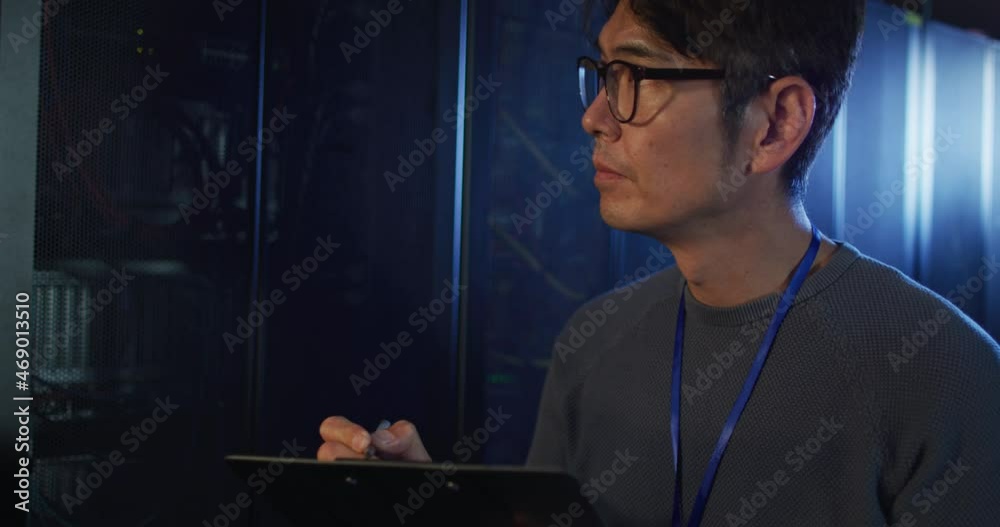 Asian male it technician using tablet checking computer server Stock ...