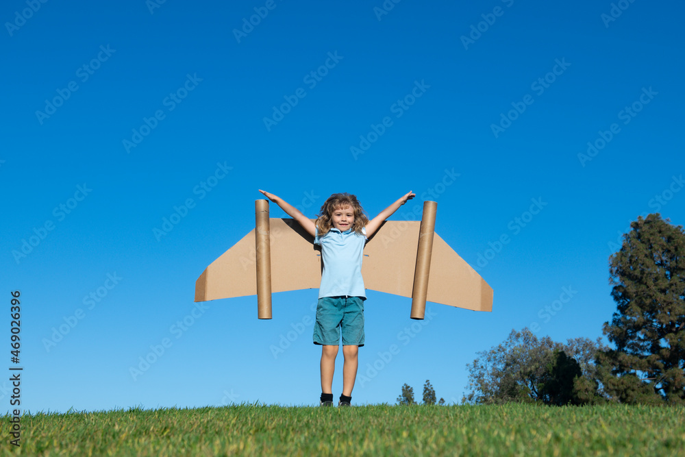 Boy child with wings at sky imagines a pilot and dreams of flying. Kids ...