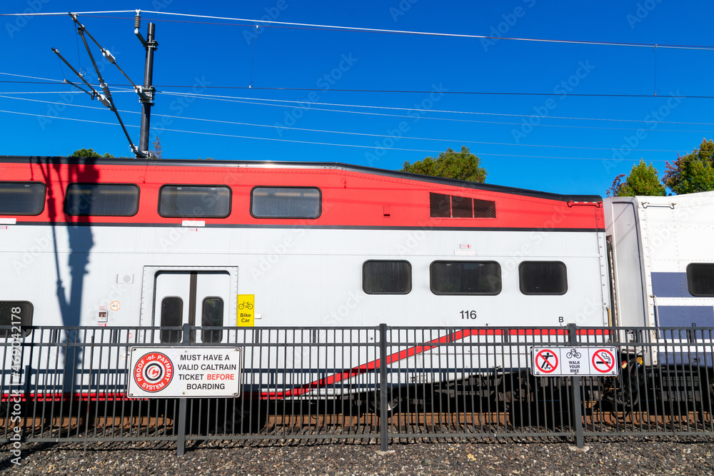 Caltrain bi-level passenger and bike car behind safety fence - San Jose ...