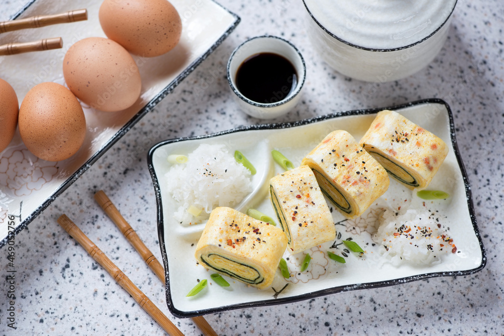 Plate with sliced tamagoyaki or sweetened japanese egg roll, elevated ...