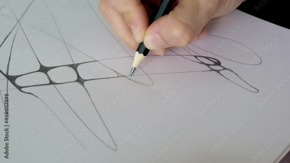 Close up of gray pencil and draw lines on paper. With a graphite pencil ...