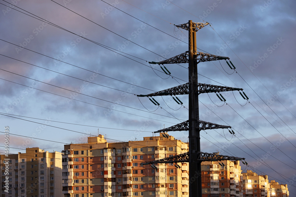 High voltage tower with electrical wires on background of residential ...