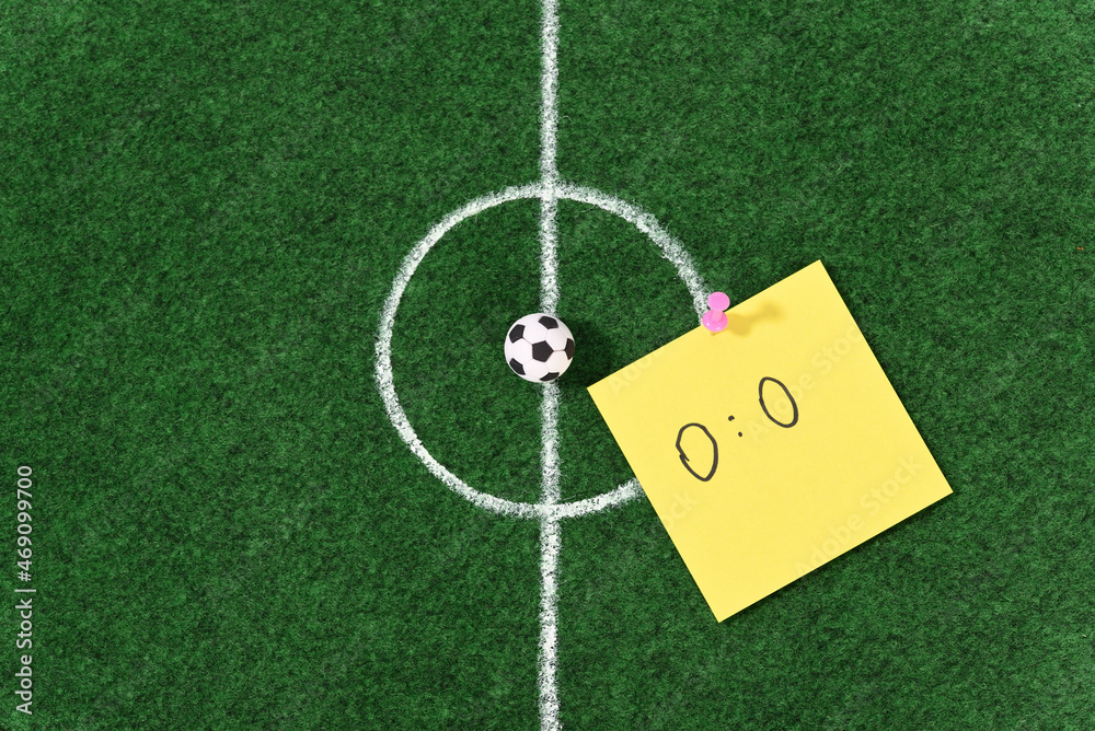 Soccer ball in the center of the soccer field and stationery push pins ...