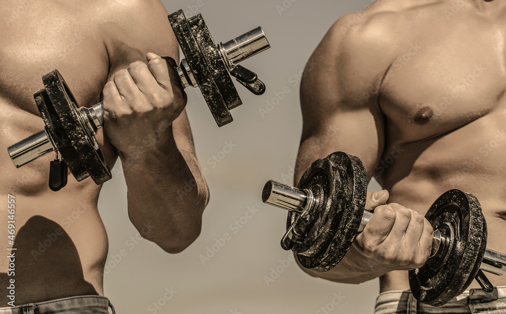 Strong bodybuilder, perfect deltoid muscles, shoulders, biceps, triceps ...