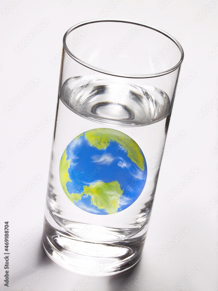 Planet earth globe inside a glass of water on global flood pollution ...