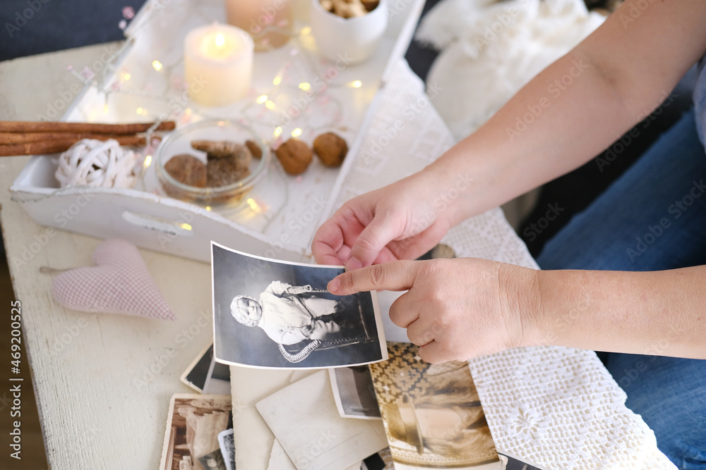 woman looking through her old photographs 1965-1970, the concept of ...