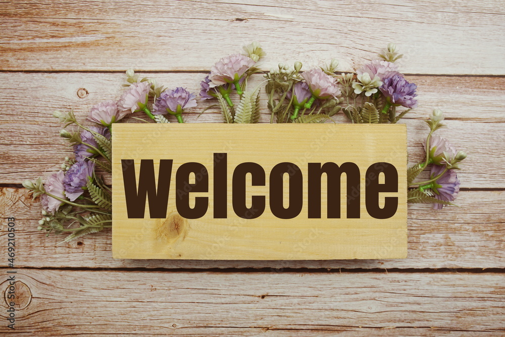 Welcome Sign with flowers frame decorate on wooden background Stock ...