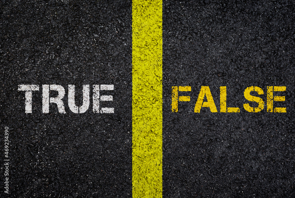 Antonym concept of TRUE versus FALSE, written on dark wet asphalt. Top ...