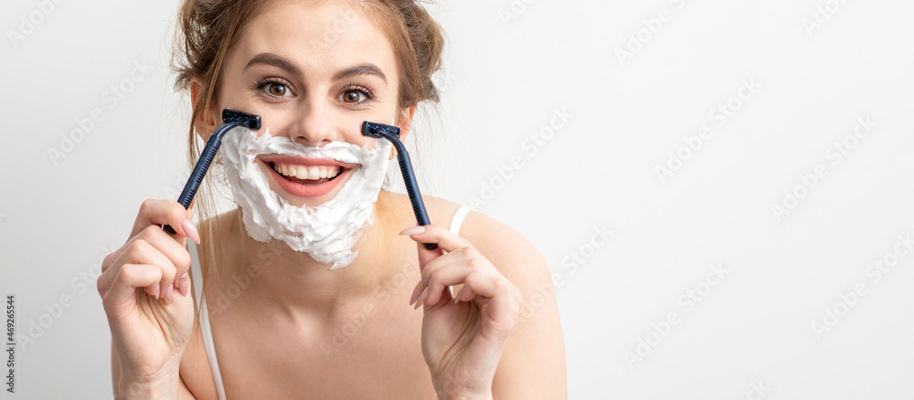 Beautiful young caucasian woman shaving her face by razor on white ...