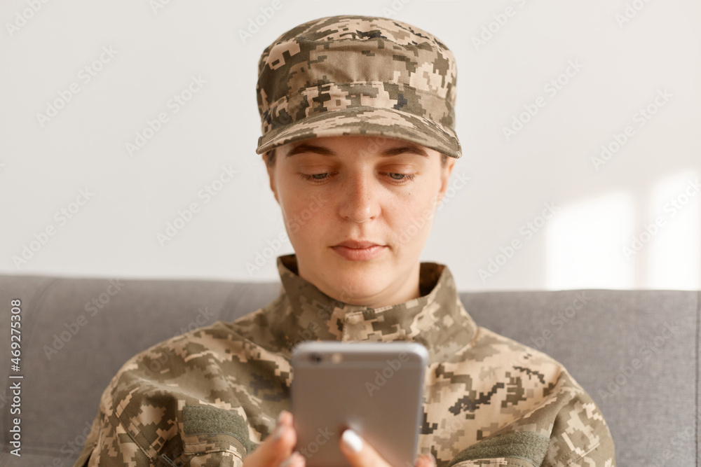 Horizontal shot of concentrated female soldier wearing military costume ...
