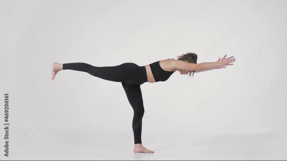 Basic yoga poses. Side view portrait of young flexible woman standing ...