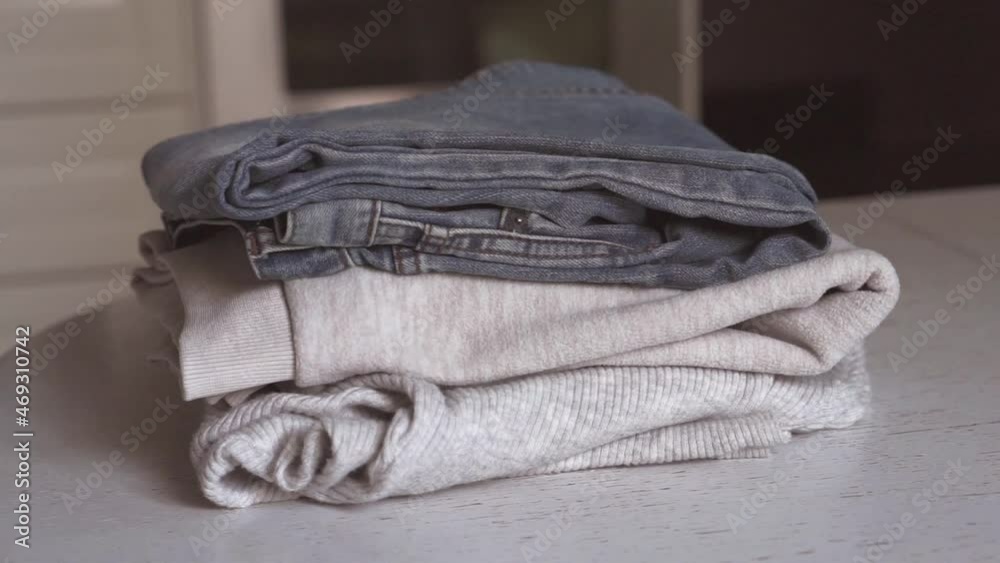 Garment recycling concept. There is a stack of clothes on the recycling ...