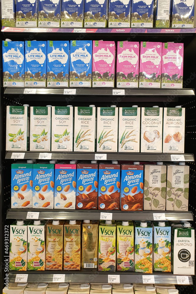 Various choice of plant based milks display on store shelves. Vegan ...