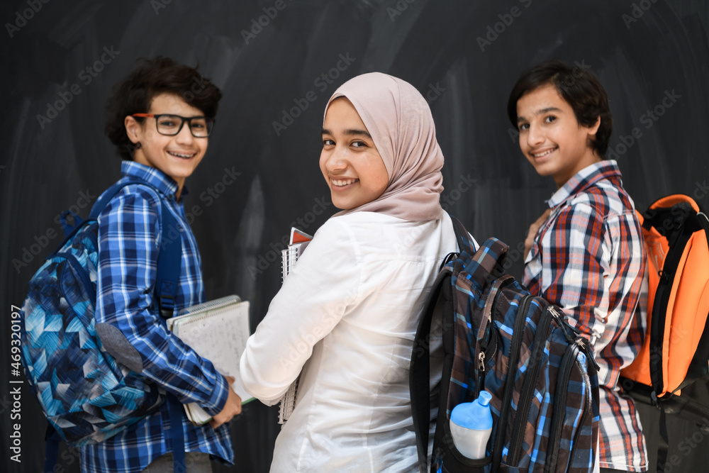 Arabic teenagers, students group portrait against black chalkboard ...